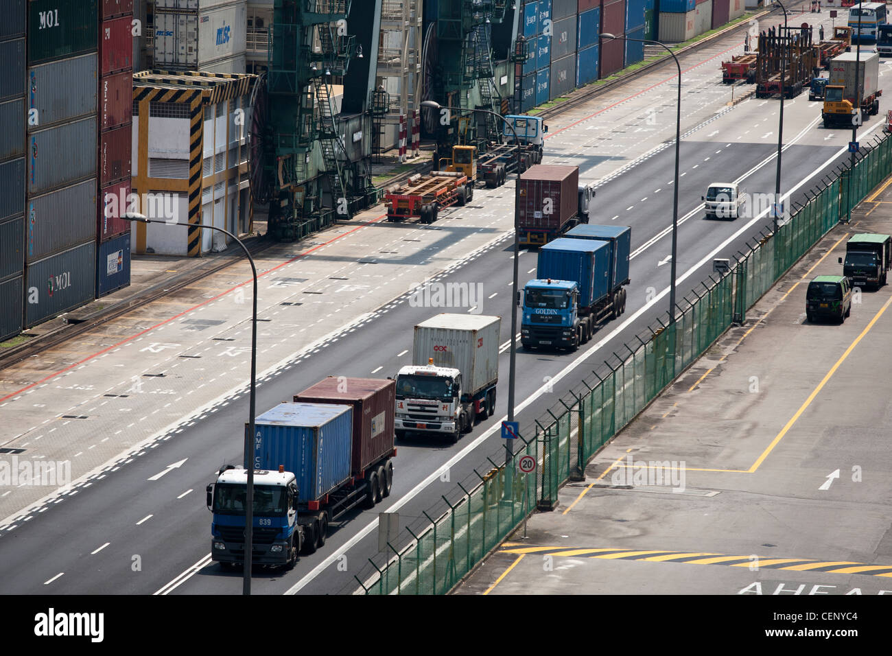 Trucks transport shipping containers at the Port of Singapore Stock ...