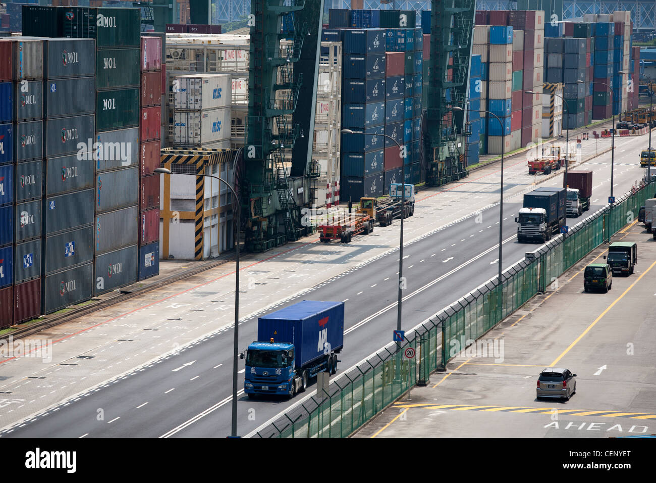 Trucks transport shipping containers at the Port of Singapore Stock ...