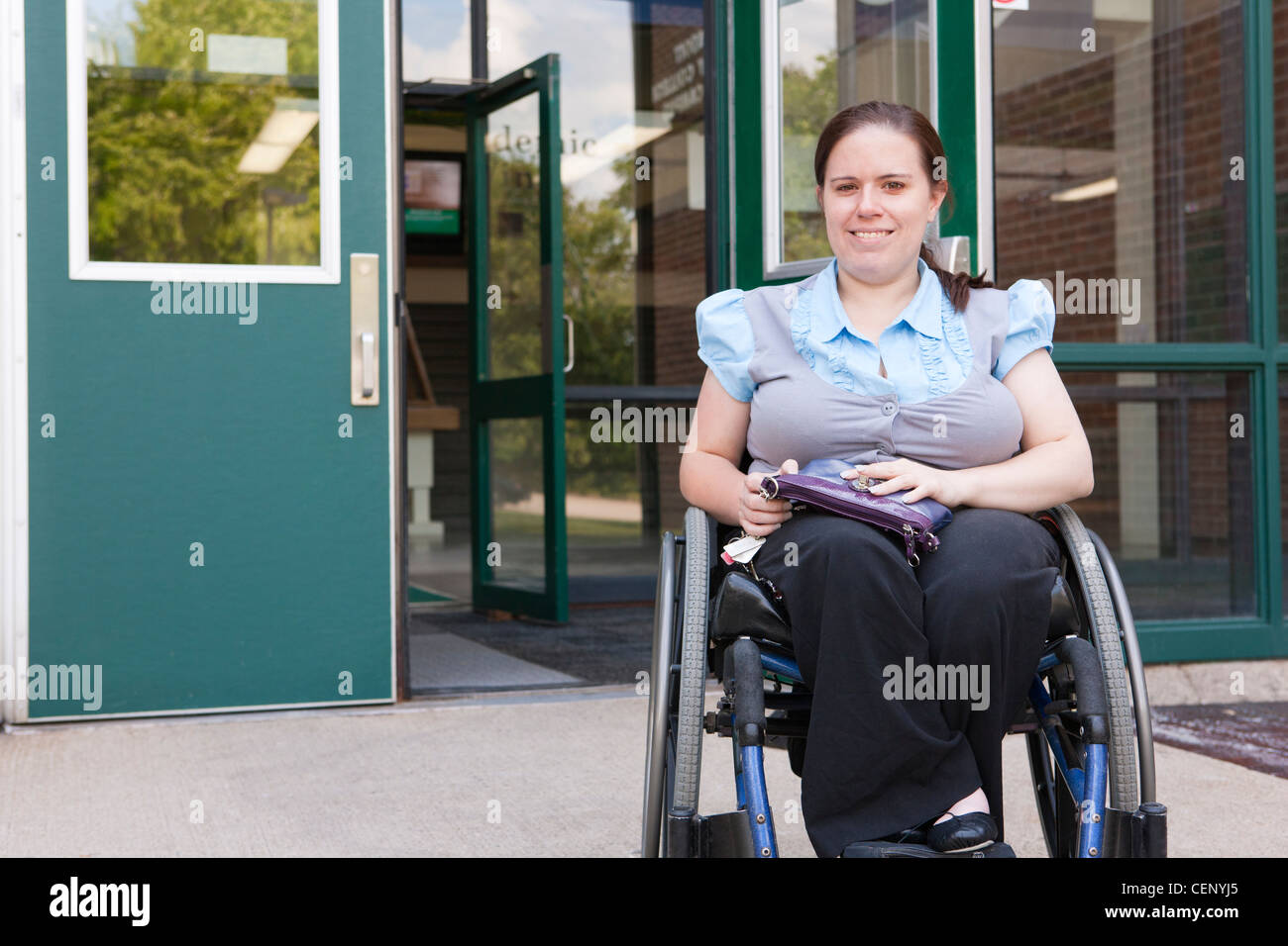 Student in wheelchair exiting school entrance Stock Photo - Alamy
