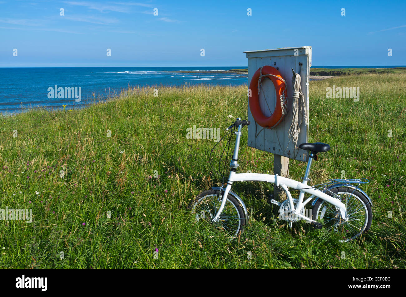 A Bike Leans On A Wooden Structure In The Grass Holding A Buoy Along ...