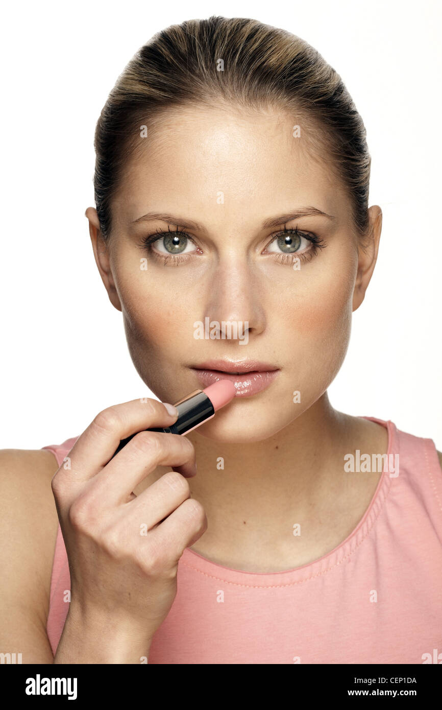Female applying pink lipstick Stock Photo - Alamy