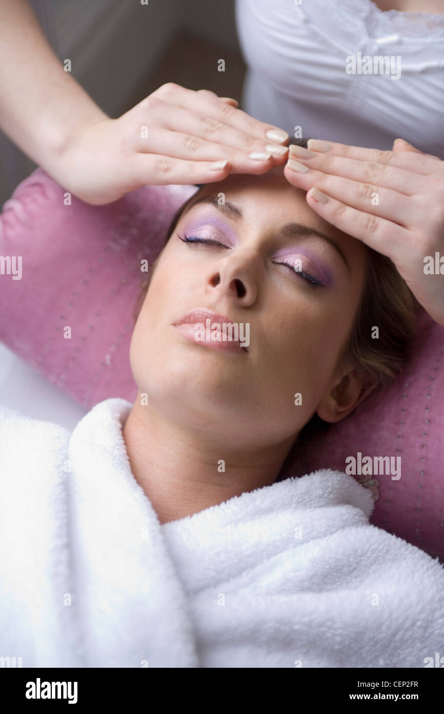 Vertical woman receiving massage reiki hi-res stock photography and ...