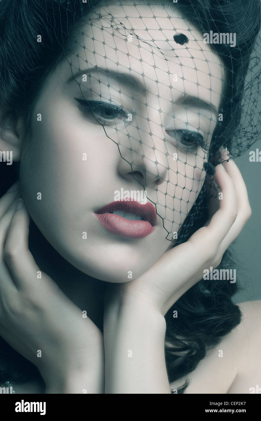 vintage female model with net over eyes and red lips Stock Photo - Alamy