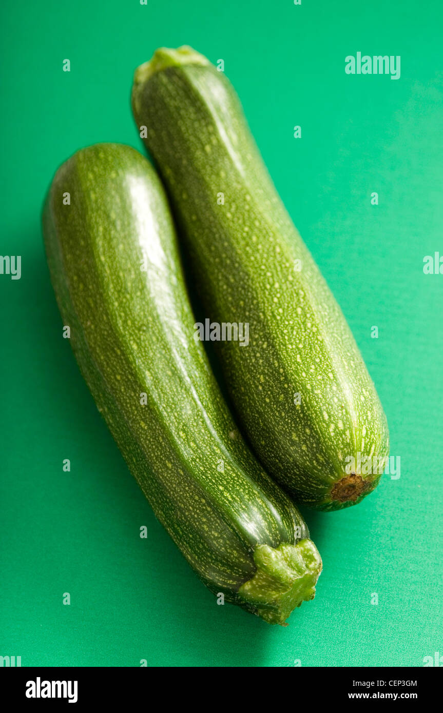 Two courgettes on a soft green background Stock Photo - Alamy