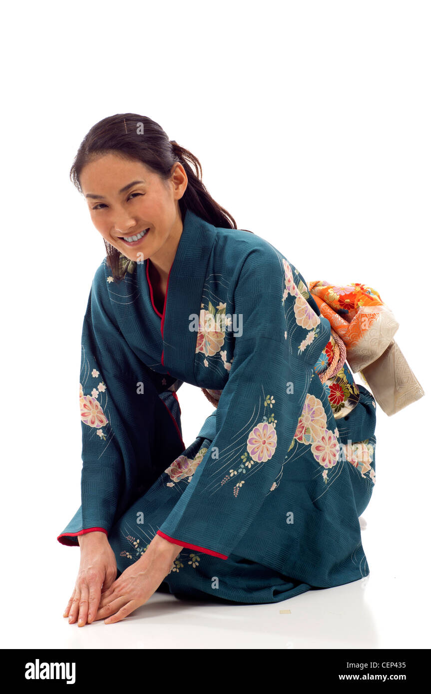 Smiling Japanese kimono woman bowing isolated over white background ...