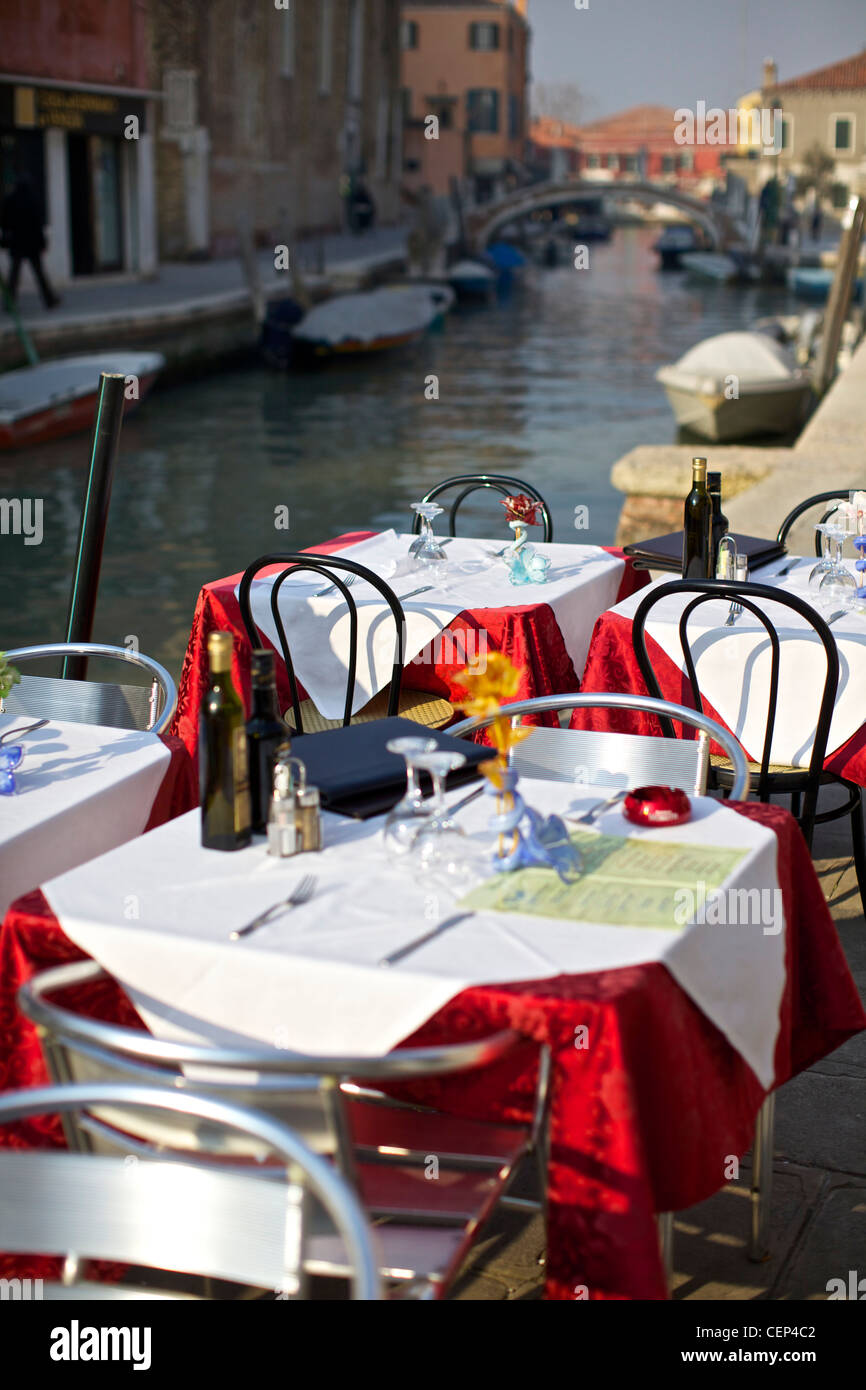 Tables on the canal side in Murano in the Venetian Lagoon in Northern ...