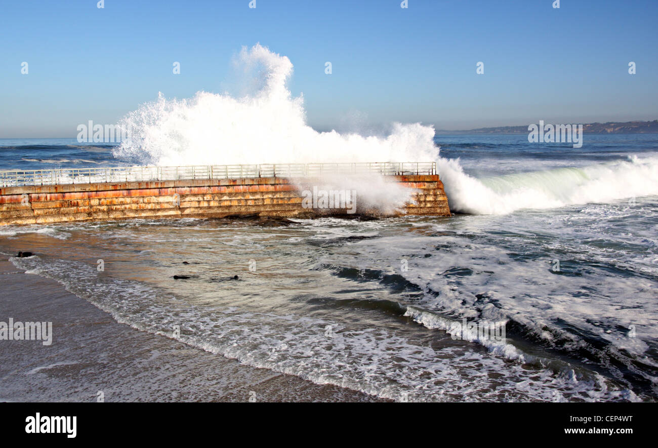 Huge wave breaking over the jetty Stock Photo - Alamy