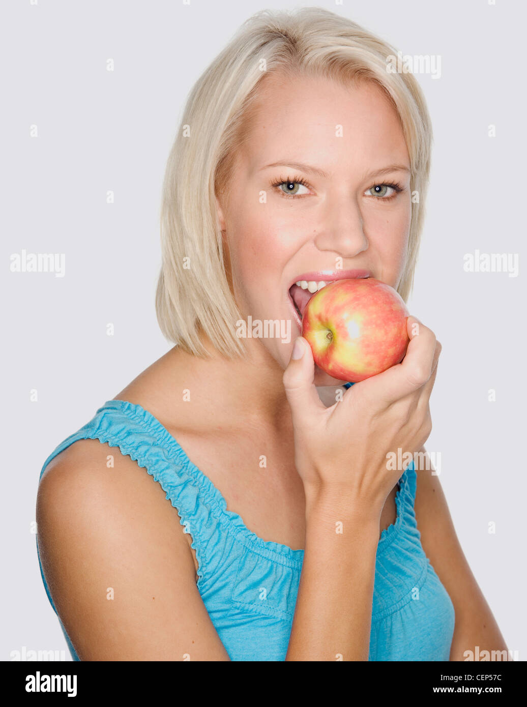 Female biting into an apple Stock Photo - Alamy