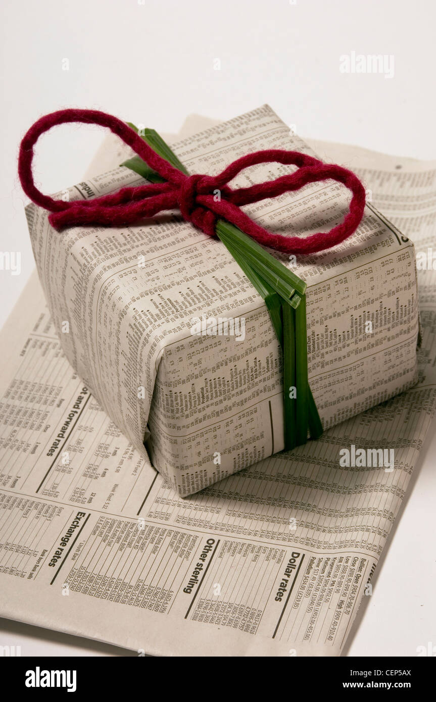 A still life of a present wrapped in newspaper steel grass wrapped ...