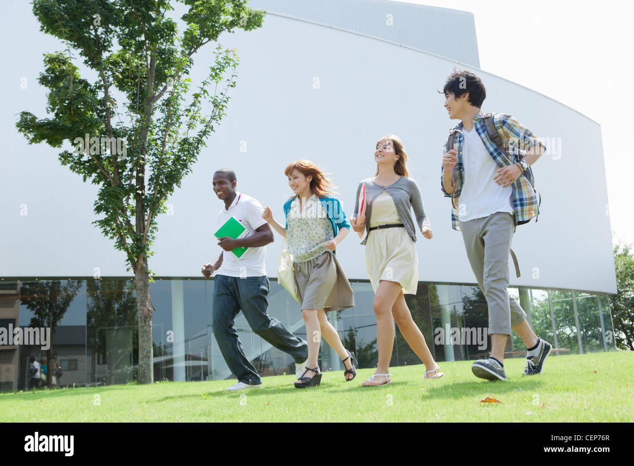 University students running on lawn Stock Photo - Alamy