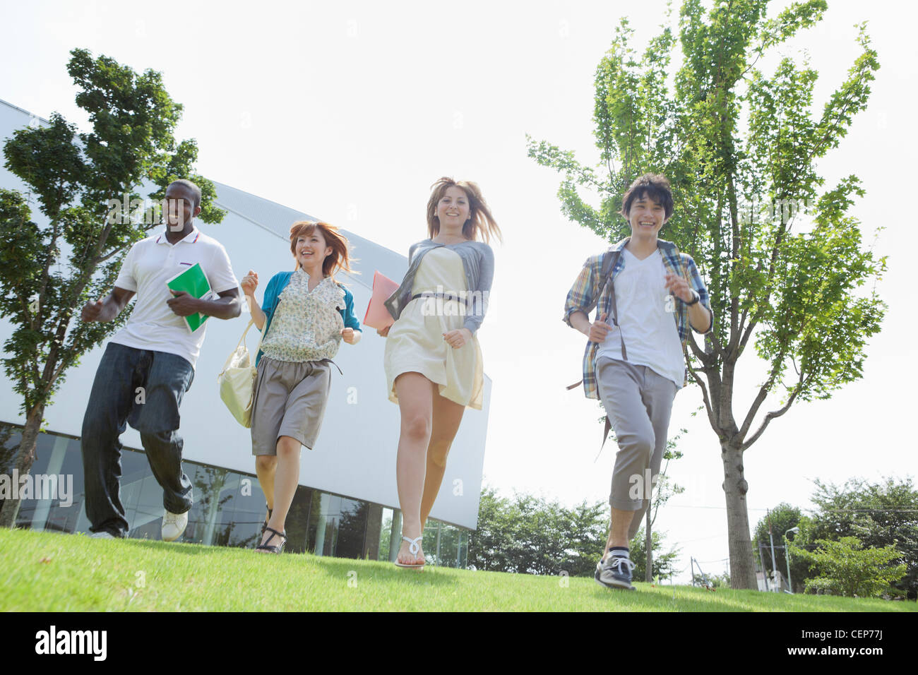 University students running on lawn Stock Photo - Alamy