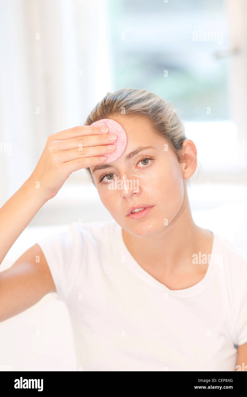 Female highlighted fair hair off her face, wearing a white t shirt ...