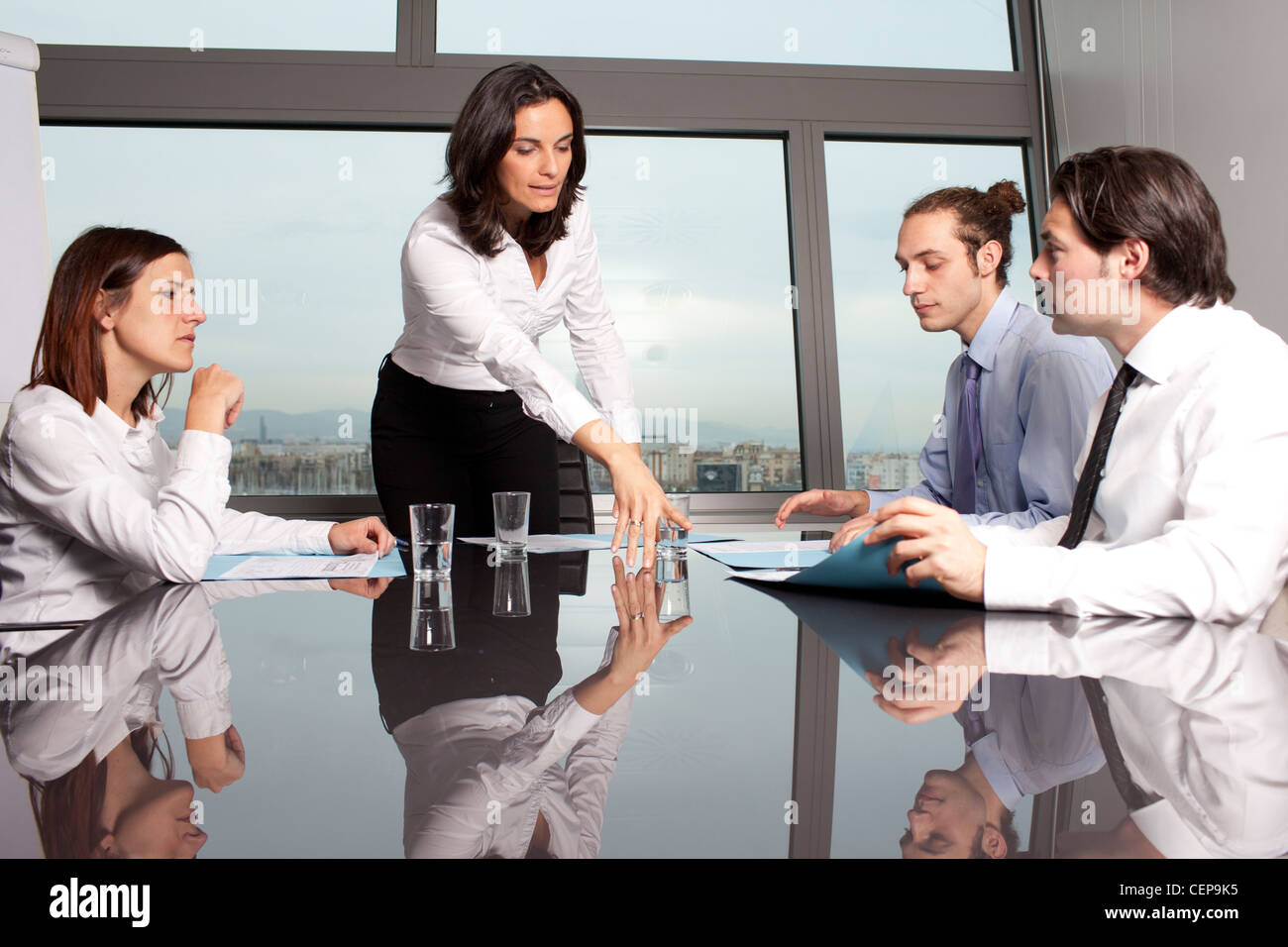 Female businesswoman explaining in office Stock Photo - Alamy