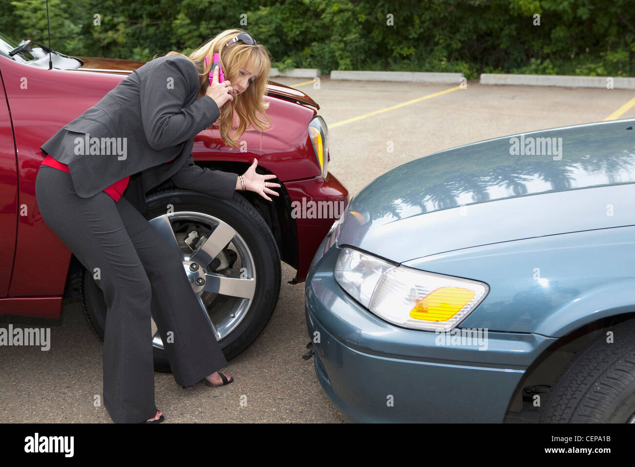 a woman makes a phone call for help after she gets into a car accident ...