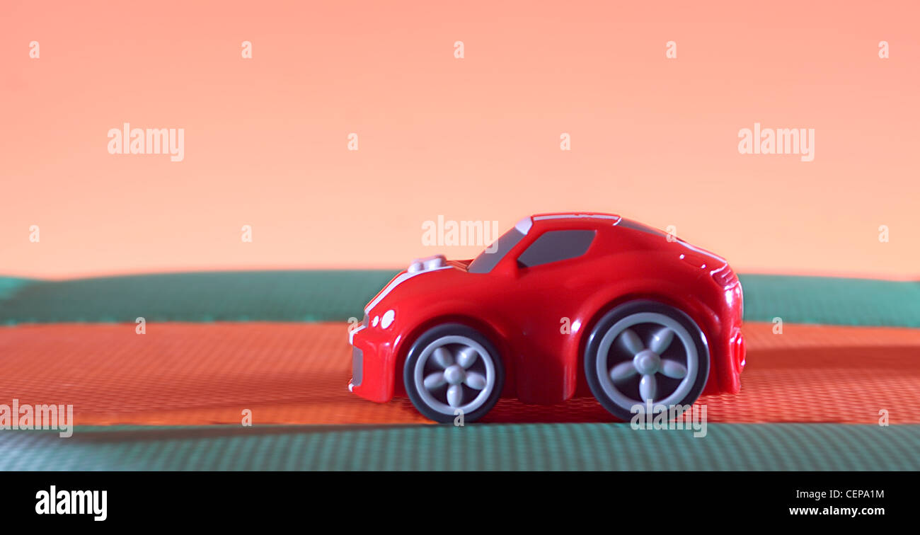 a little red car moving fast Stock Photo - Alamy