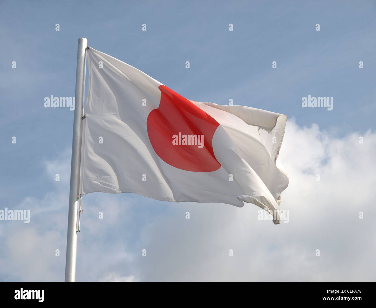 Flag of Japan over a blue sky Stock Photo - Alamy