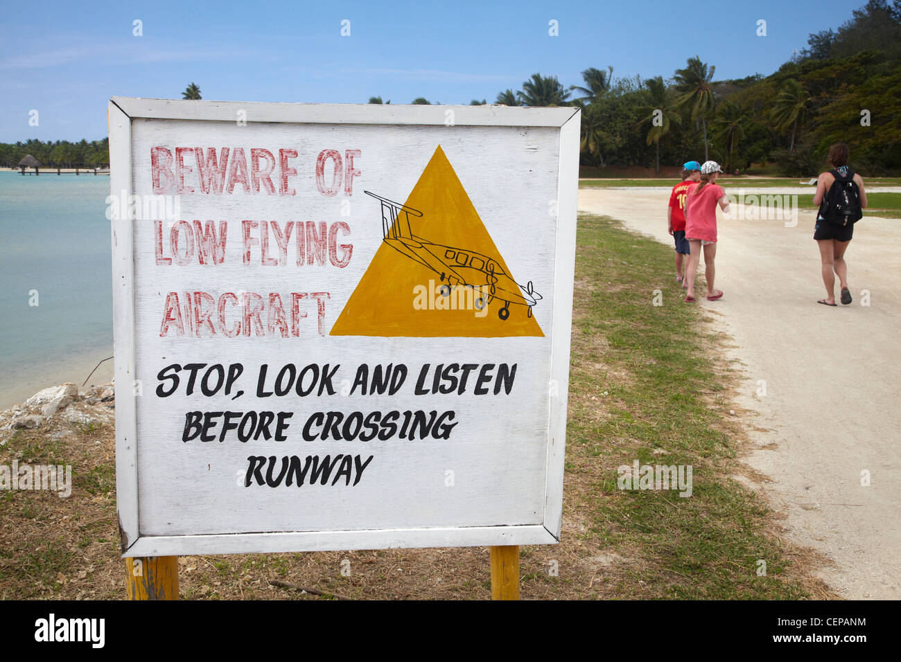 Warning sign beside footpath across runway, between resorts, Malolo ...