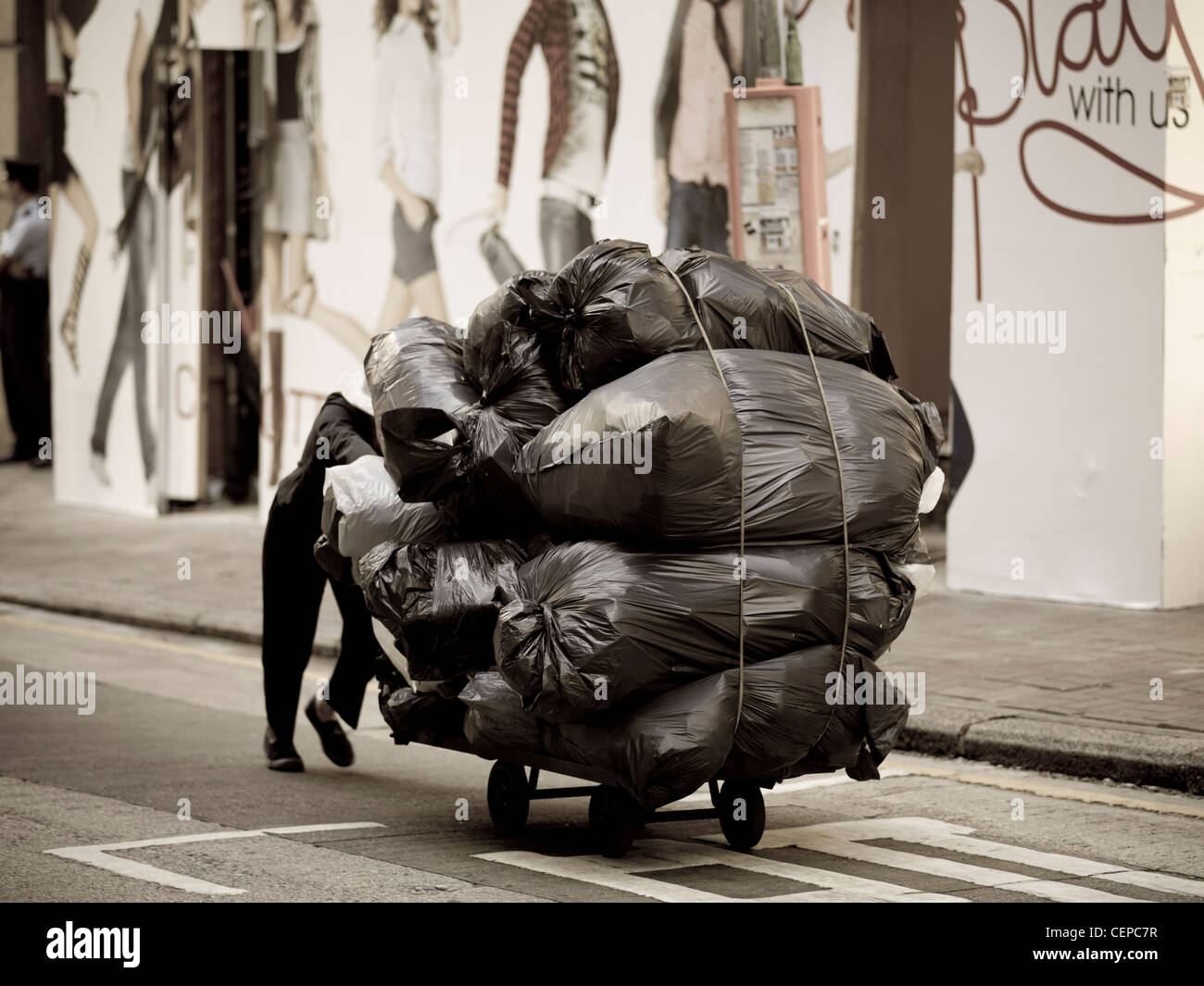 Person Carting Garbage Bags Down A Street; Hong Kong,China Stock Photo ...