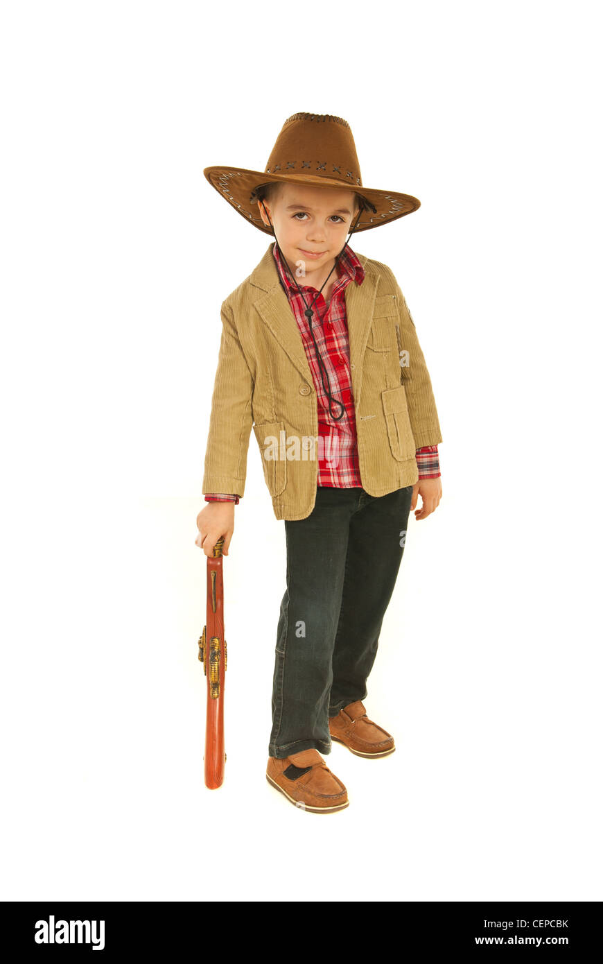 Small cowboy resting his hand on a weapon toy isolated on white ...