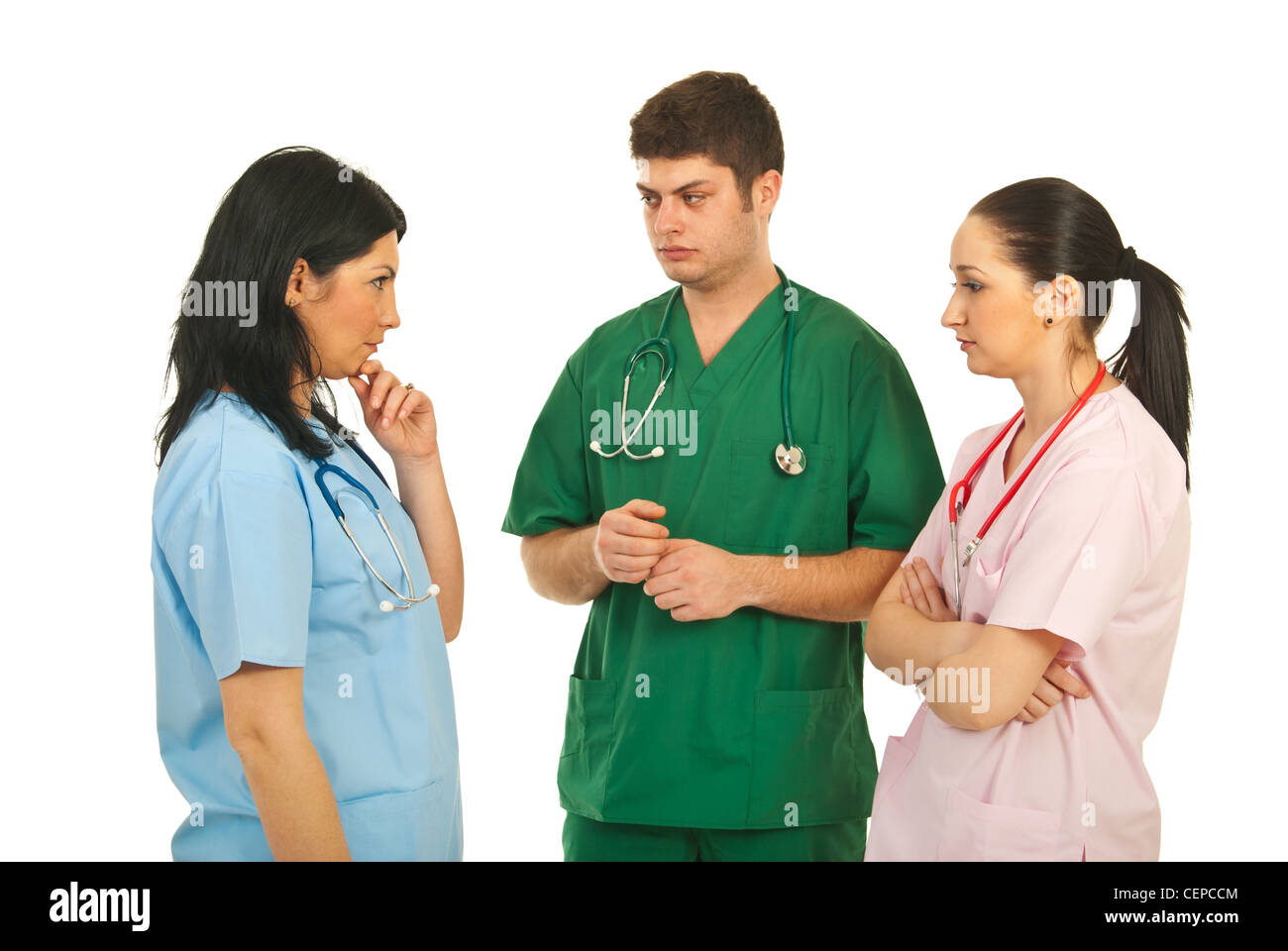 Sad team of three doctors having conversation and thinking at solutions ...