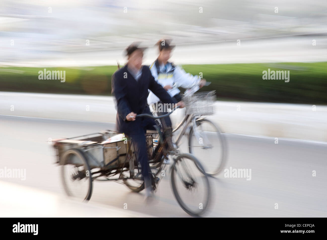 Two People Riding Bicycles Stock Photo - Alamy