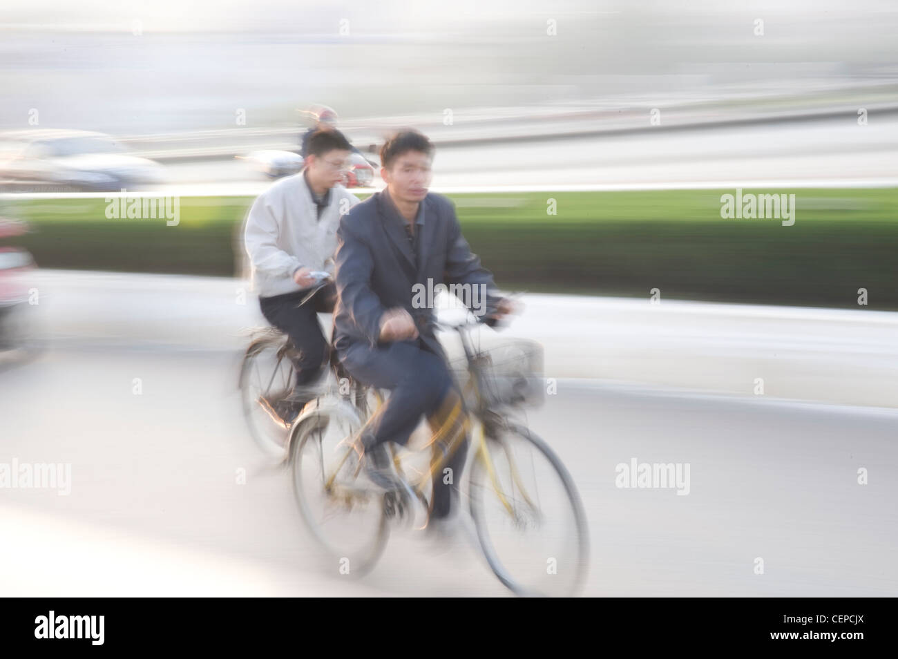 Two People Riding Bicycles Stock Photo - Alamy