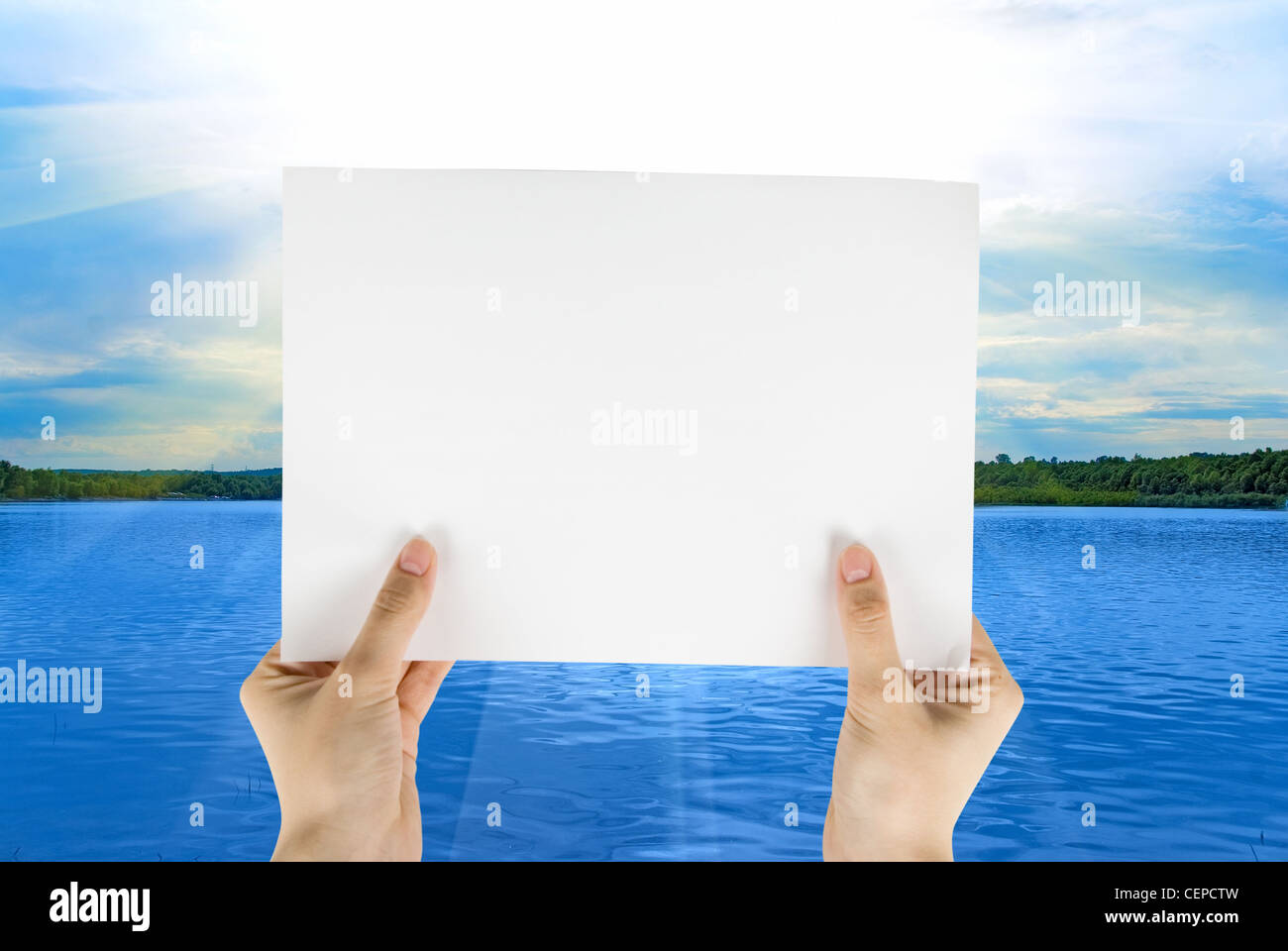 Hand holding white paper at beauty sunset on sea background Stock Photo ...