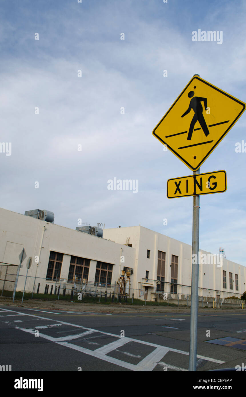 Yellow and black people crossing sign Stock Photo - Alamy