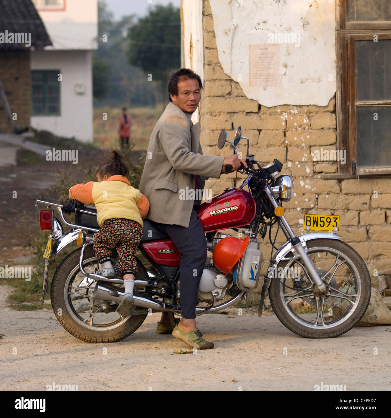 Man And Child Getting On A Motorcycle Stock Photo - Alamy