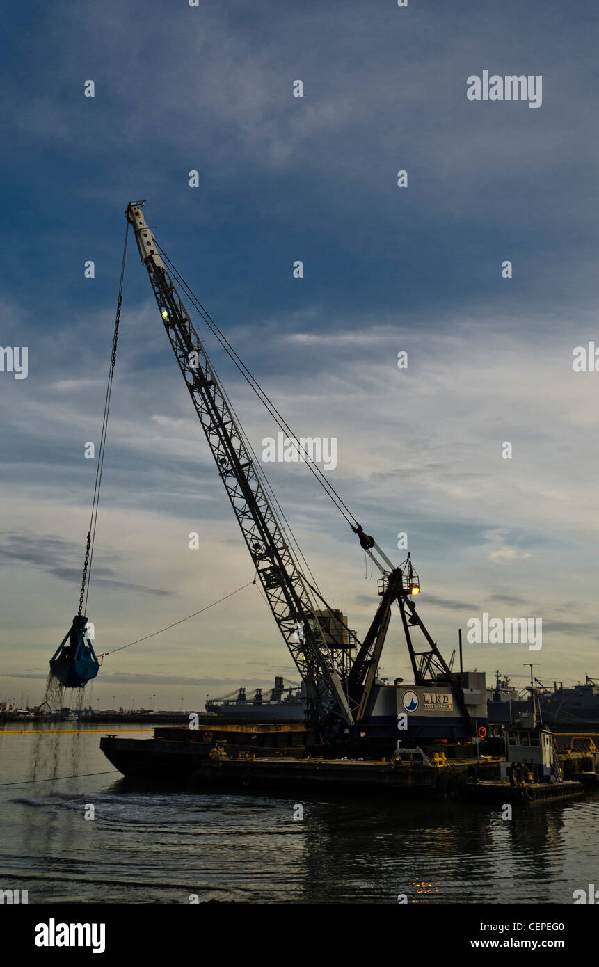 Crane dredge barge performing environmental clean up in the Seaplane ...