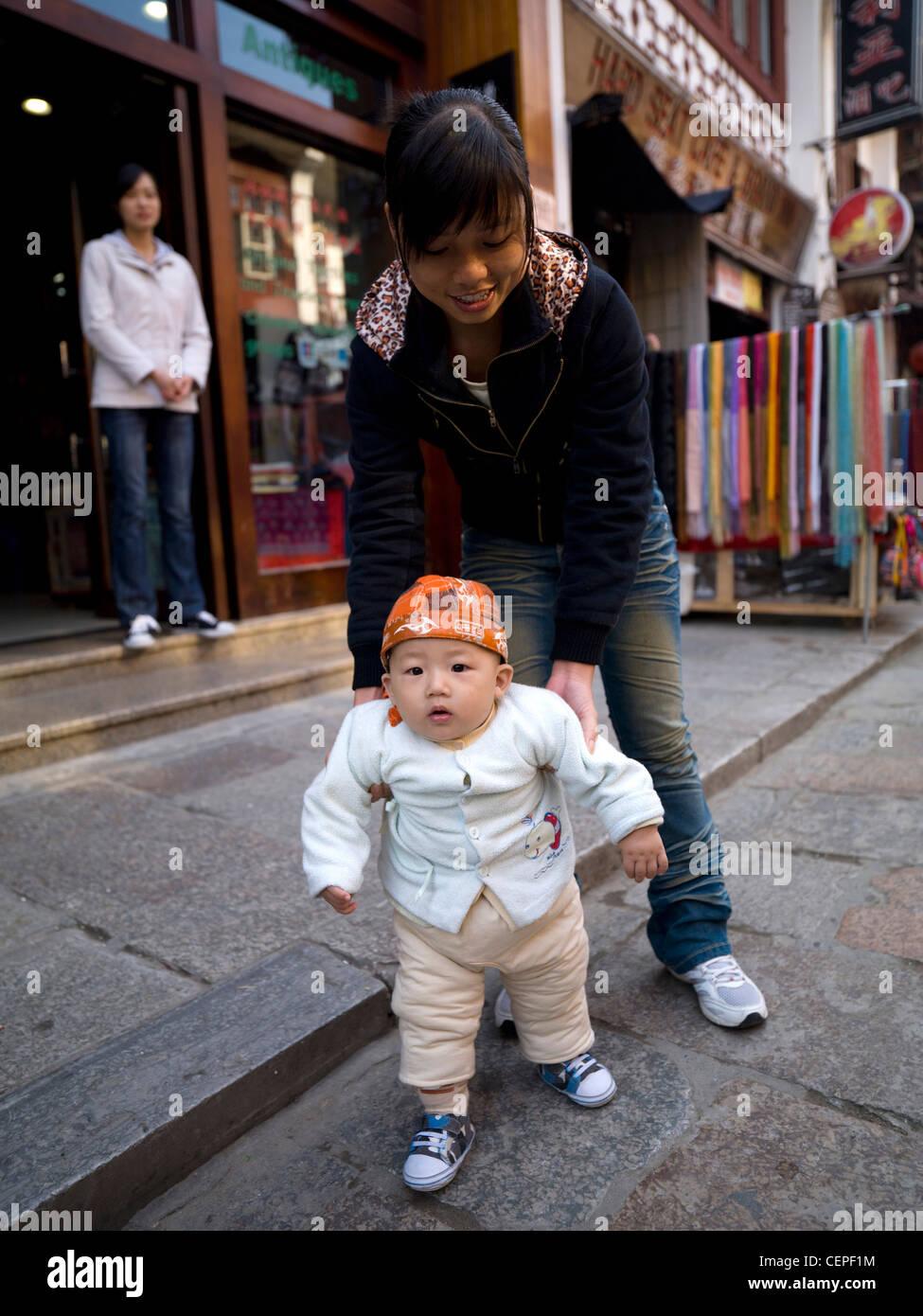 Woman And Child Outside Store Stock Photo - Alamy