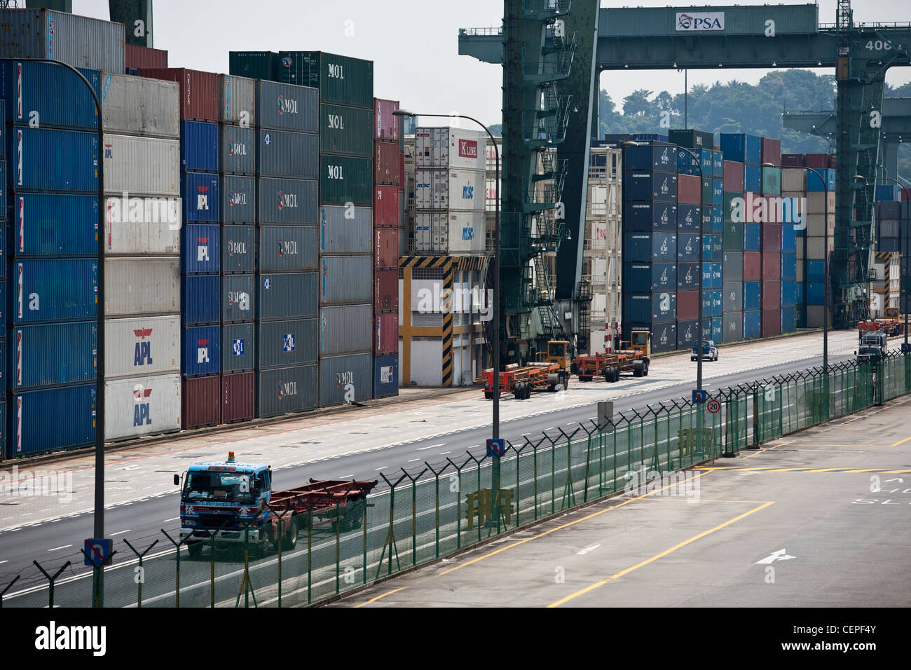 Trucks transport shipping containers at the Port of Singapore Stock ...