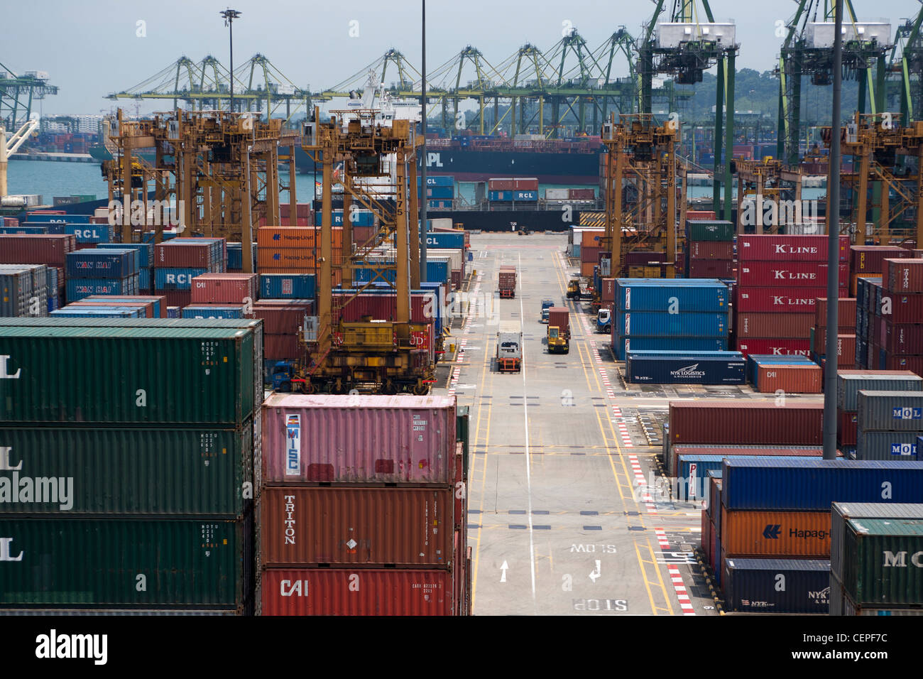 Trucks transport shipping containers at the Port of Singapore Stock ...