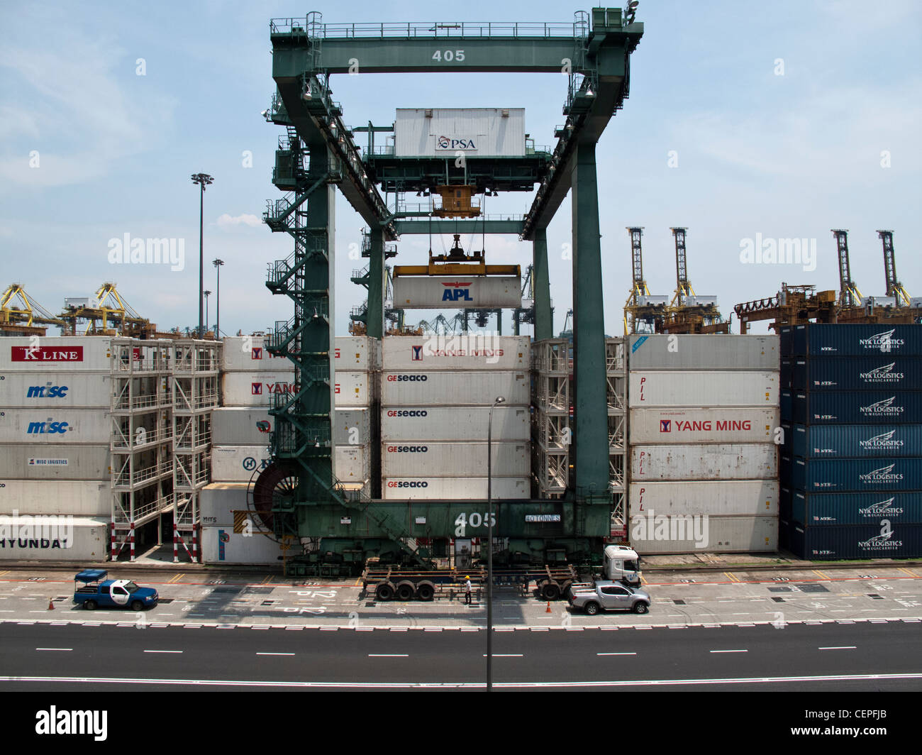 A truck is loaded with a cargo container at the Port of Singapore Stock ...