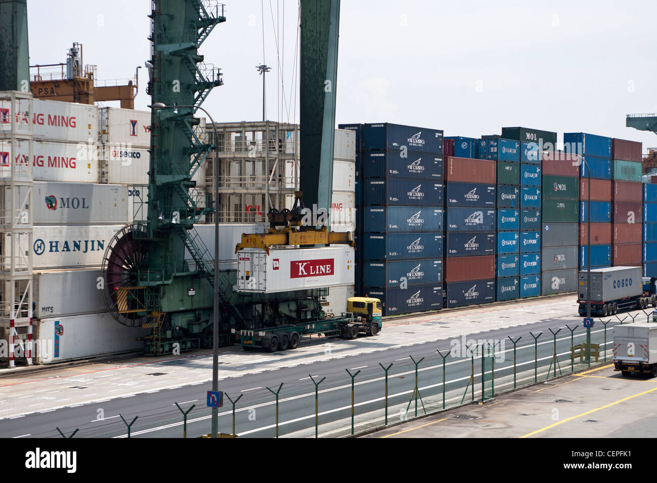 A truck is loaded with a cargo container at the Port of Singapore Stock ...