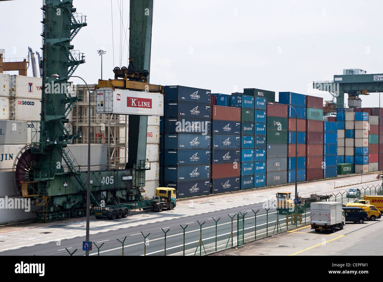 A truck is loaded with a cargo container at the Port of Singapore Stock ...