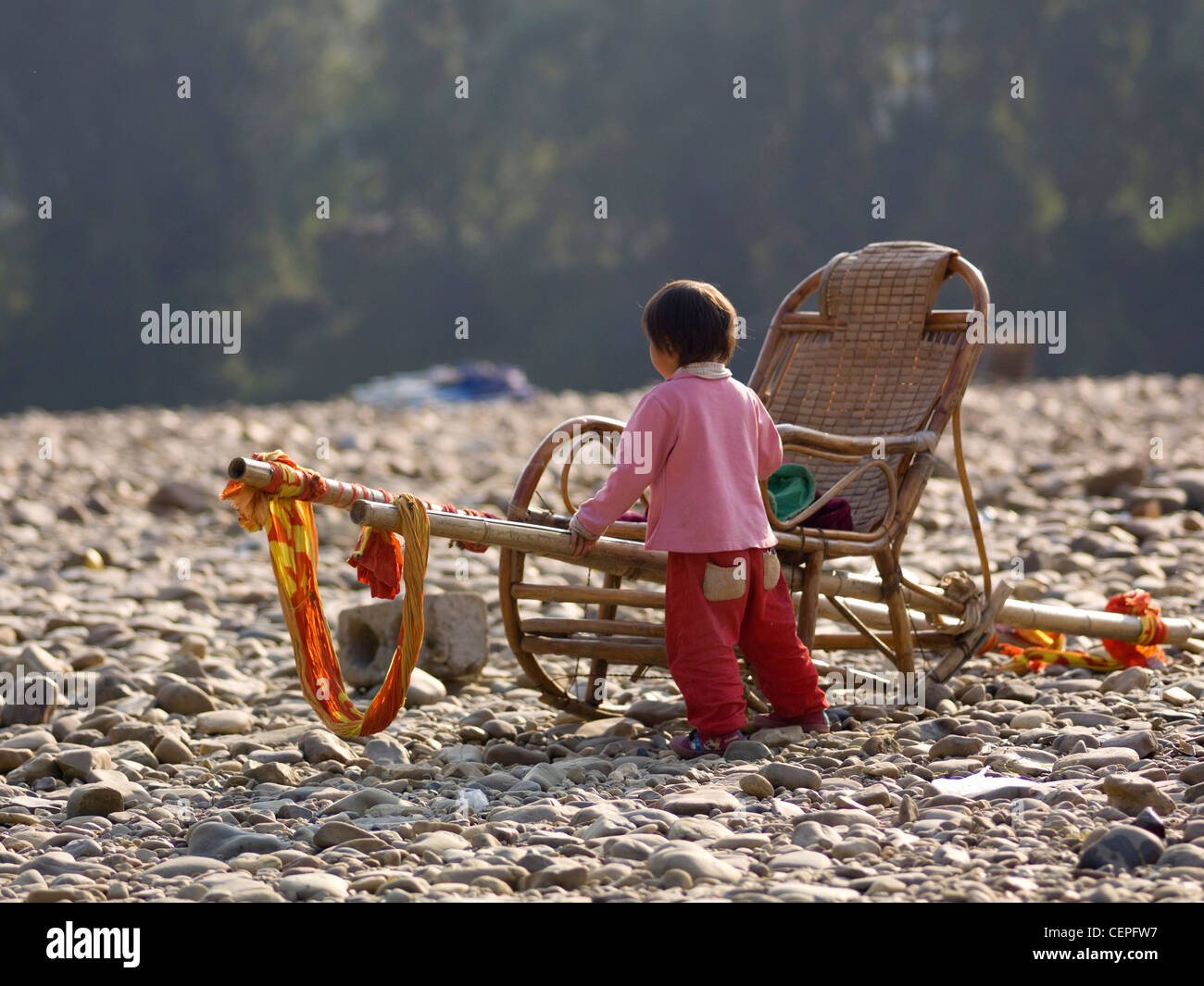 Young Girl And A Carrying Chair Stock Photo - Alamy