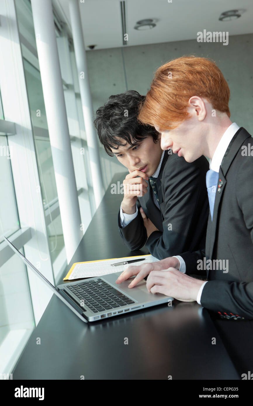 Two businessmen working with laptop Stock Photo - Alamy