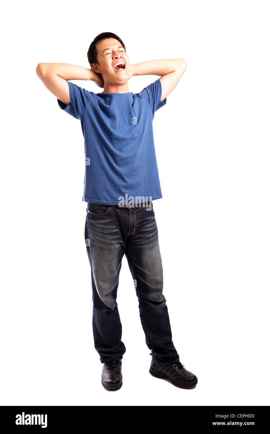 Full length image of a laughing young man stand isolated on white ...