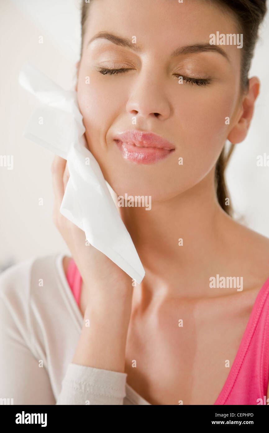 Woman taking off makeup with facial tissue Stock Photo - Alamy