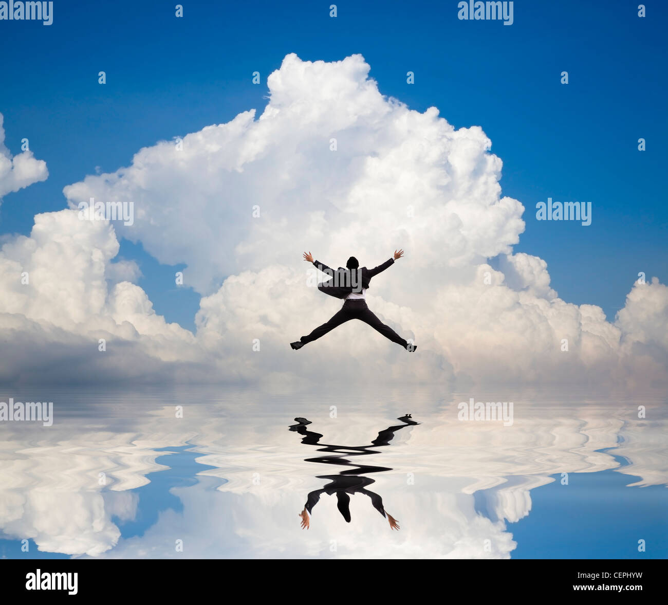 businessman jumping on the water and Reflection with cloud background ...