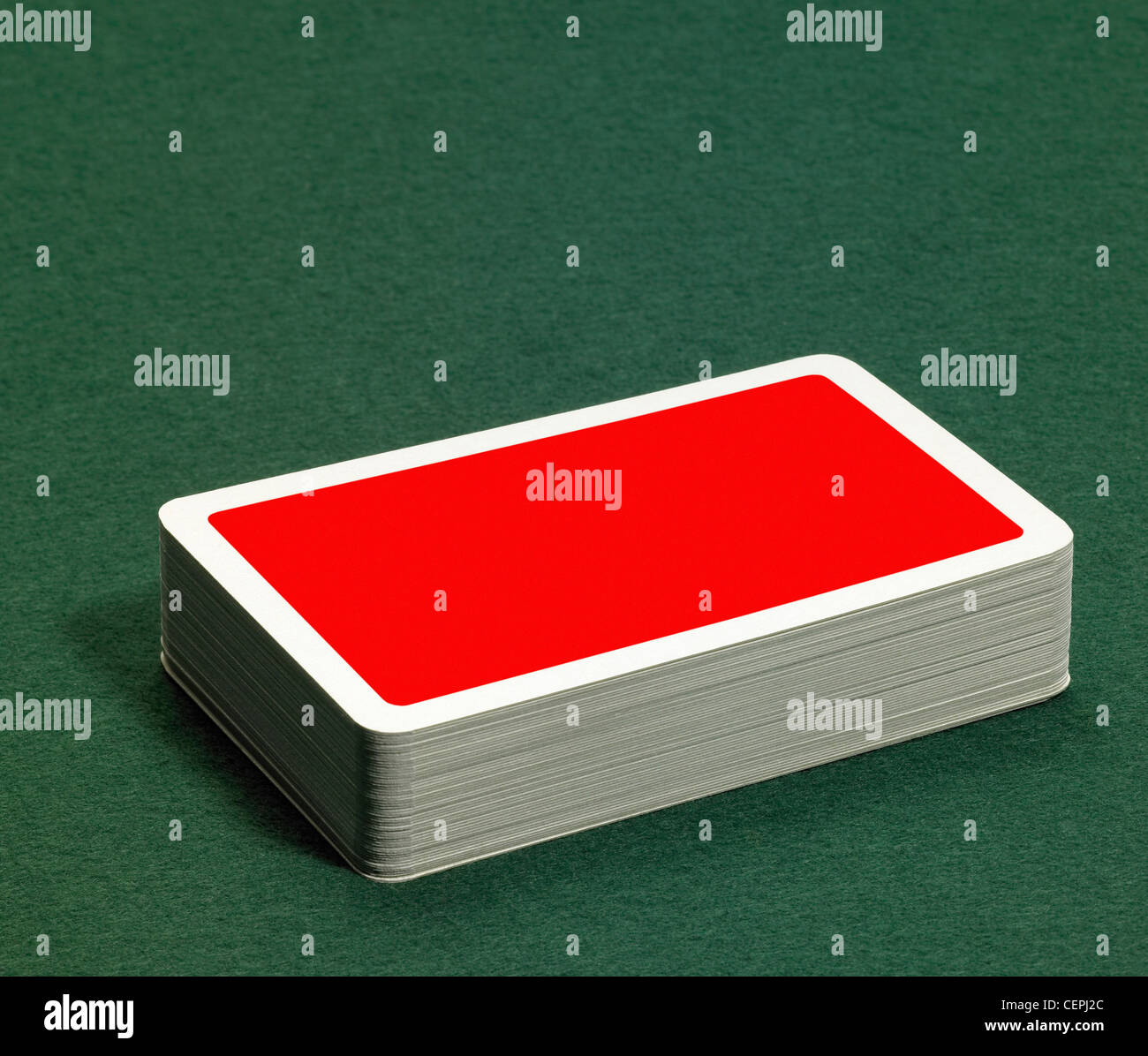 low angle studio photography showing a stack of red playing cards on ...