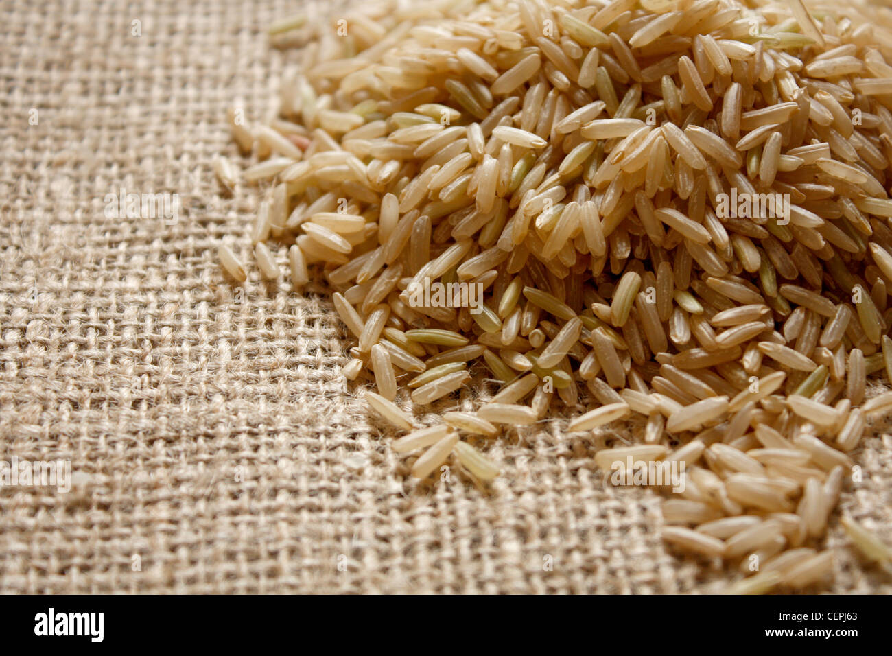 Brown rice on a textile background Stock Photo - Alamy