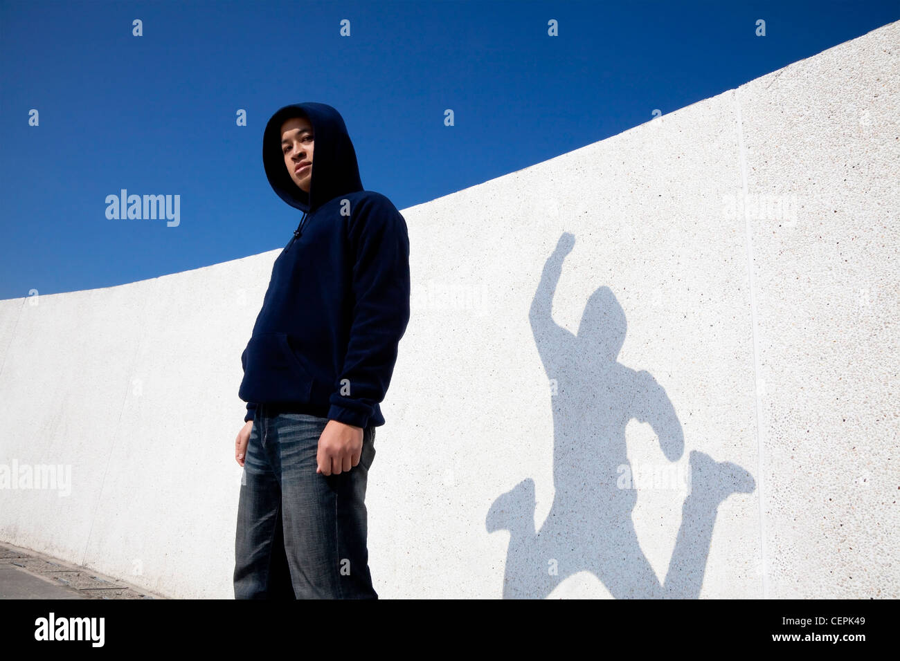 Asian teenager and dancing shadow on the white wall Stock Photo - Alamy