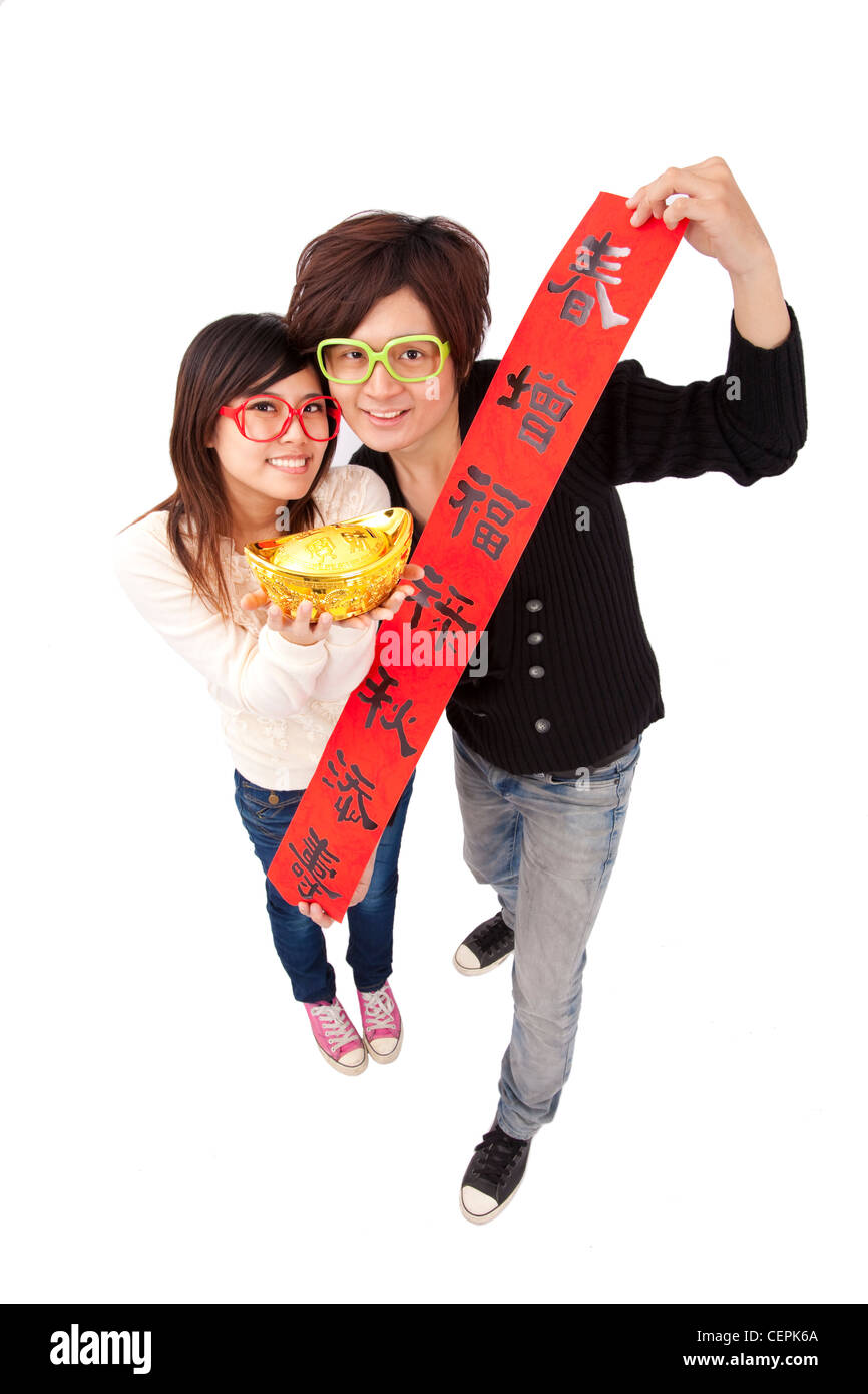 Happy chinese new year. Young couple holding gold ingot and red spring ...