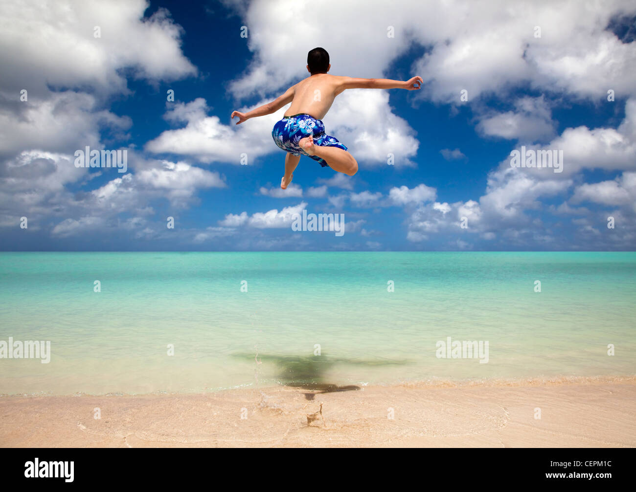 Happy young man jumping on the beach Stock Photo - Alamy
