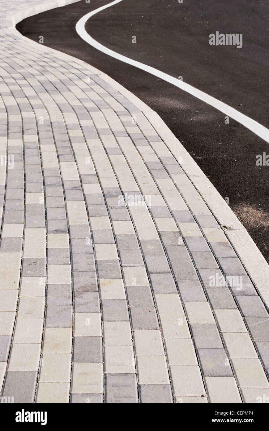 Sidewalk and street curve detail, stone patterns leading your way Stock ...