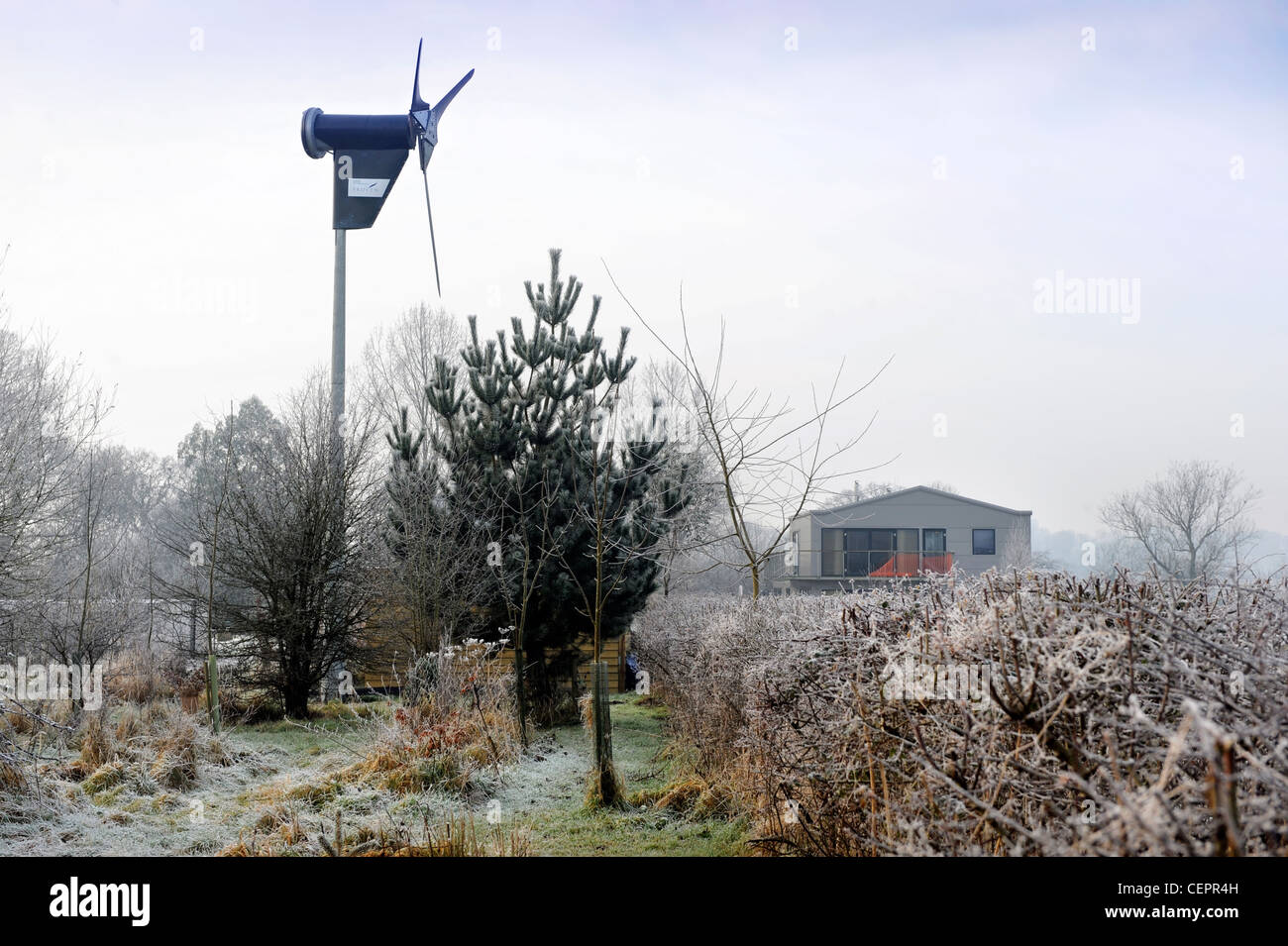 A wind turbine in the garden of a family self built home in Somerset UK ...