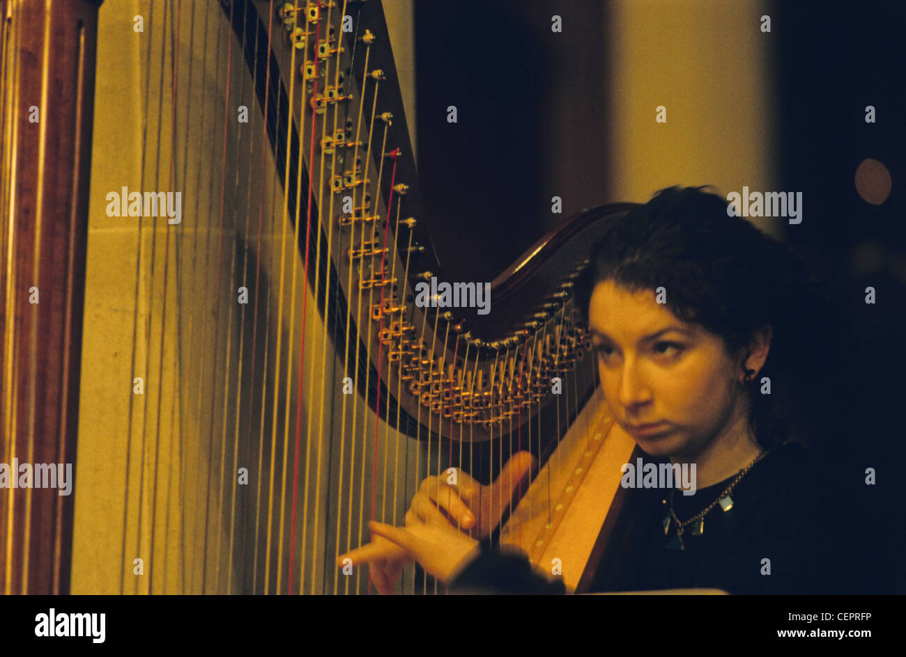 Playing the harp Stock Photo - Alamy