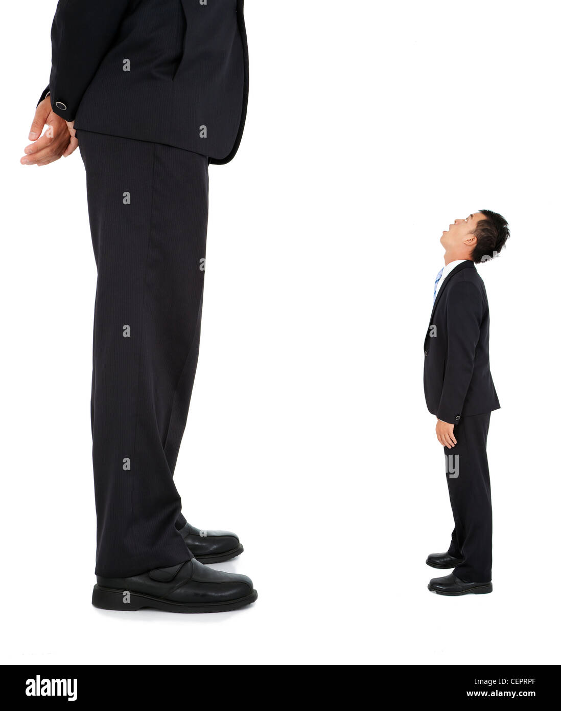 Little businessman looked at a giant businessman Stock Photo - Alamy